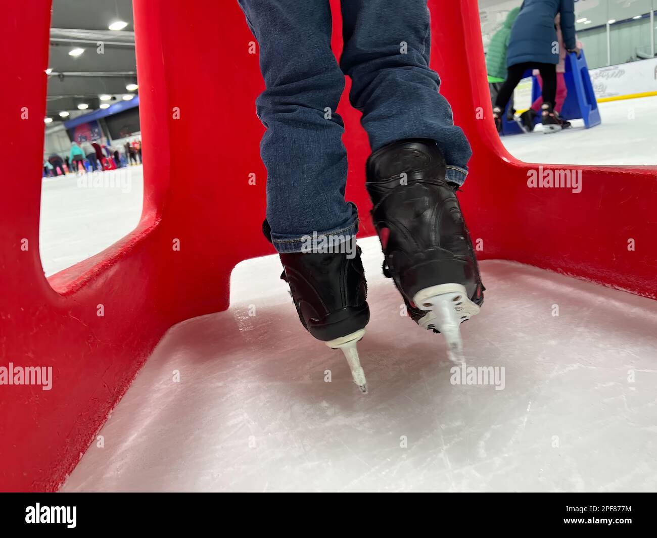 Beginner ice skater using a plastic walker for assistance Stock Photo ...
