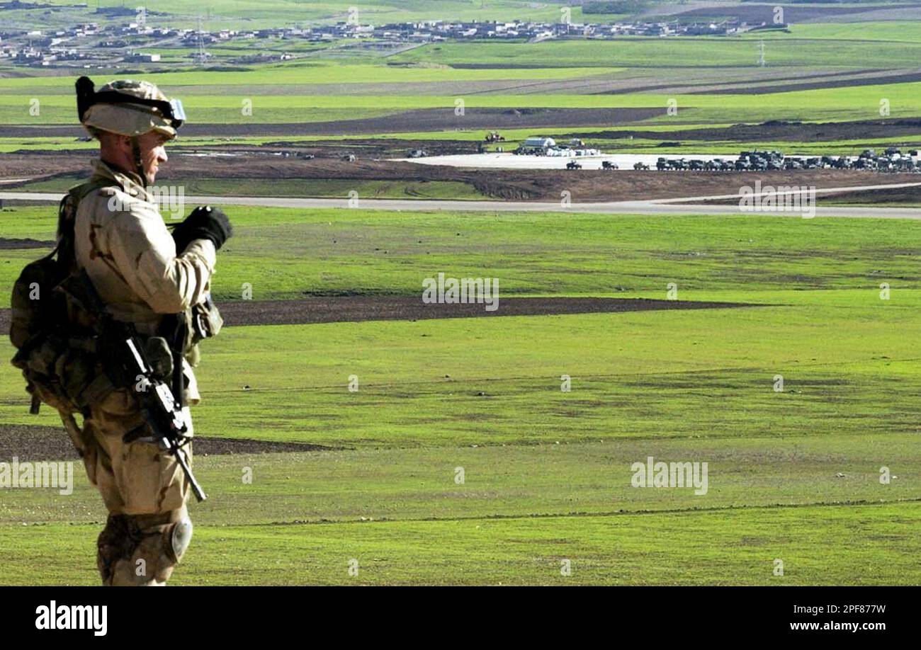 A paratrooper of the U.S. Army's 173rd Airborne Brigade guards the ...