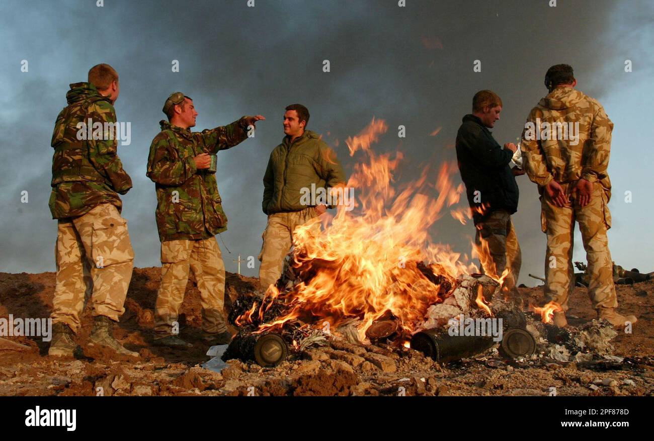 British soldiers from 29 Commando Regiment Royal Artillery gather round ...