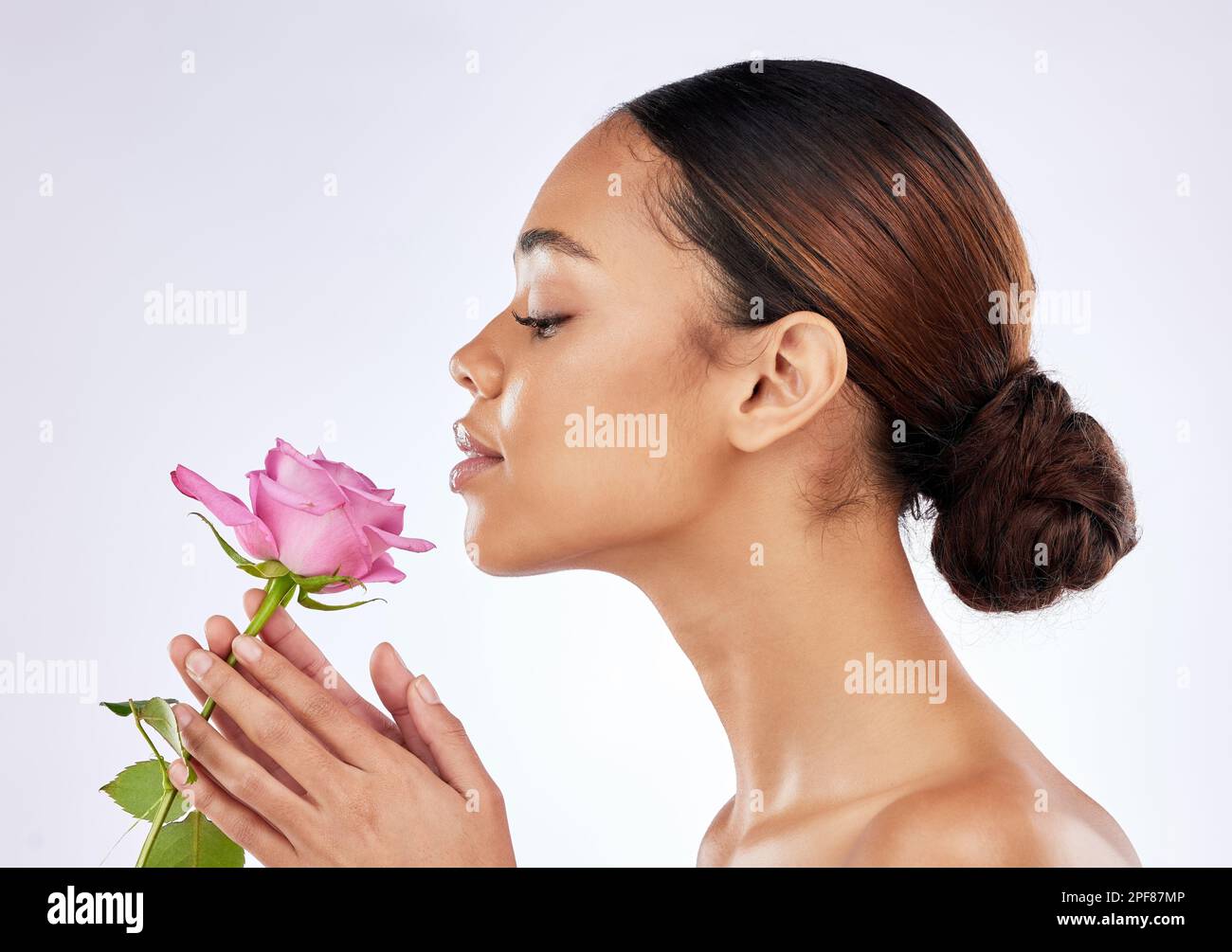 Dont pass up the chance. a young woman posing holding a rose against a ...