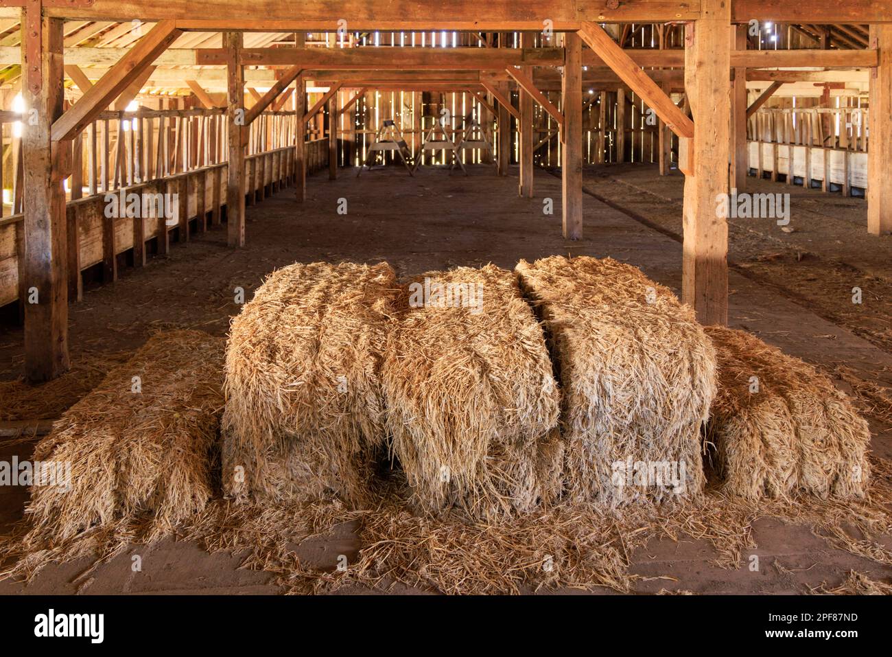 Hay bales stacked in old wooden barn on historic cattle ranch Stock ...