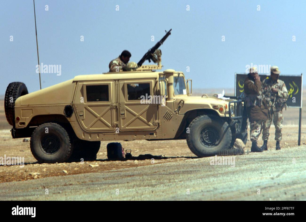 Jordanian army soldiers, one with a machine gun atop a vehicle, secure ...