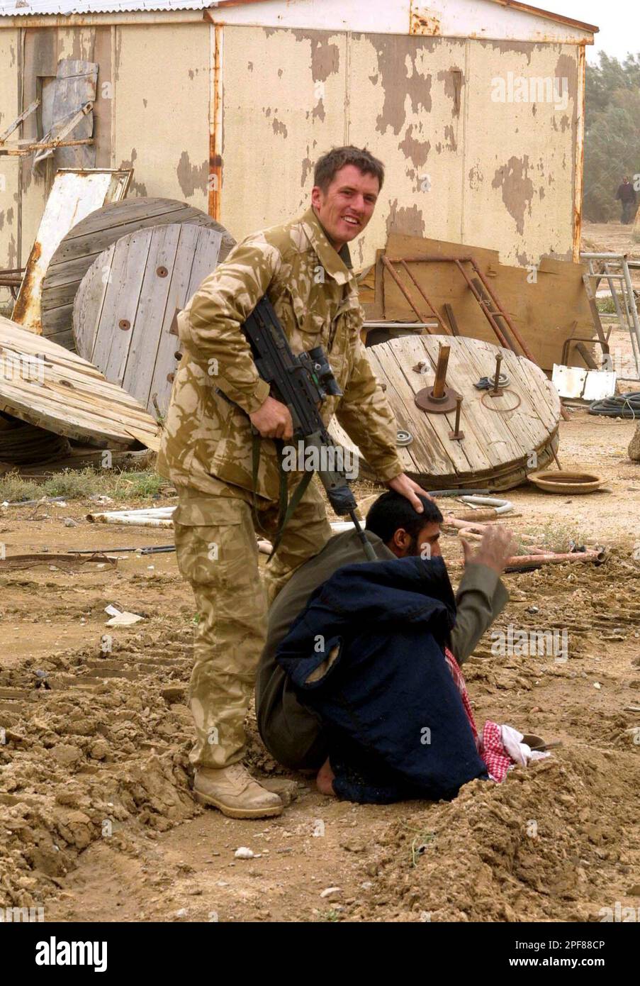 British Z company, of the Desert Rats, stops an alleged looter near a ...