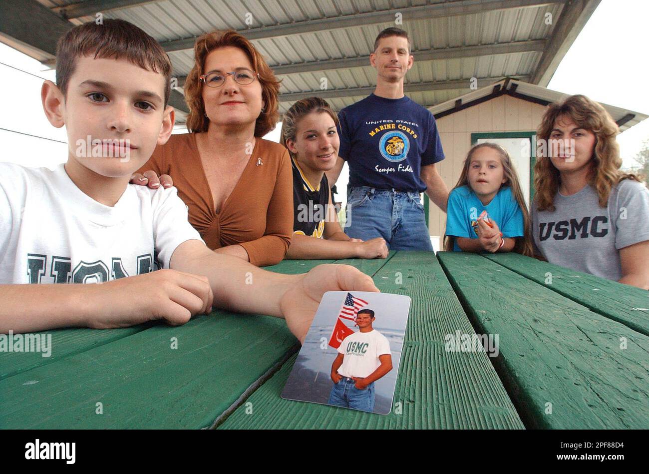 Quade Menard, 10, holds a photo of his brother , U.S. Marine Lance Cpl ...