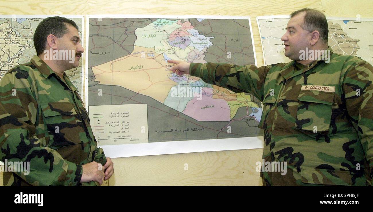 U.S. Army Contractors, Iraqi-Americans Bassam Mrad, left looks at his ...