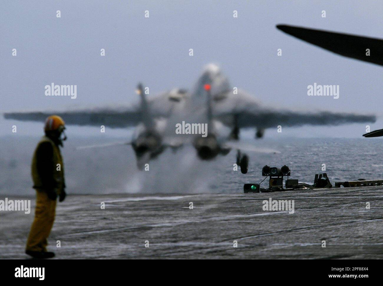 An F-14 Tomcat is launched off the USS Theodore Roosevelt for a CAS ...