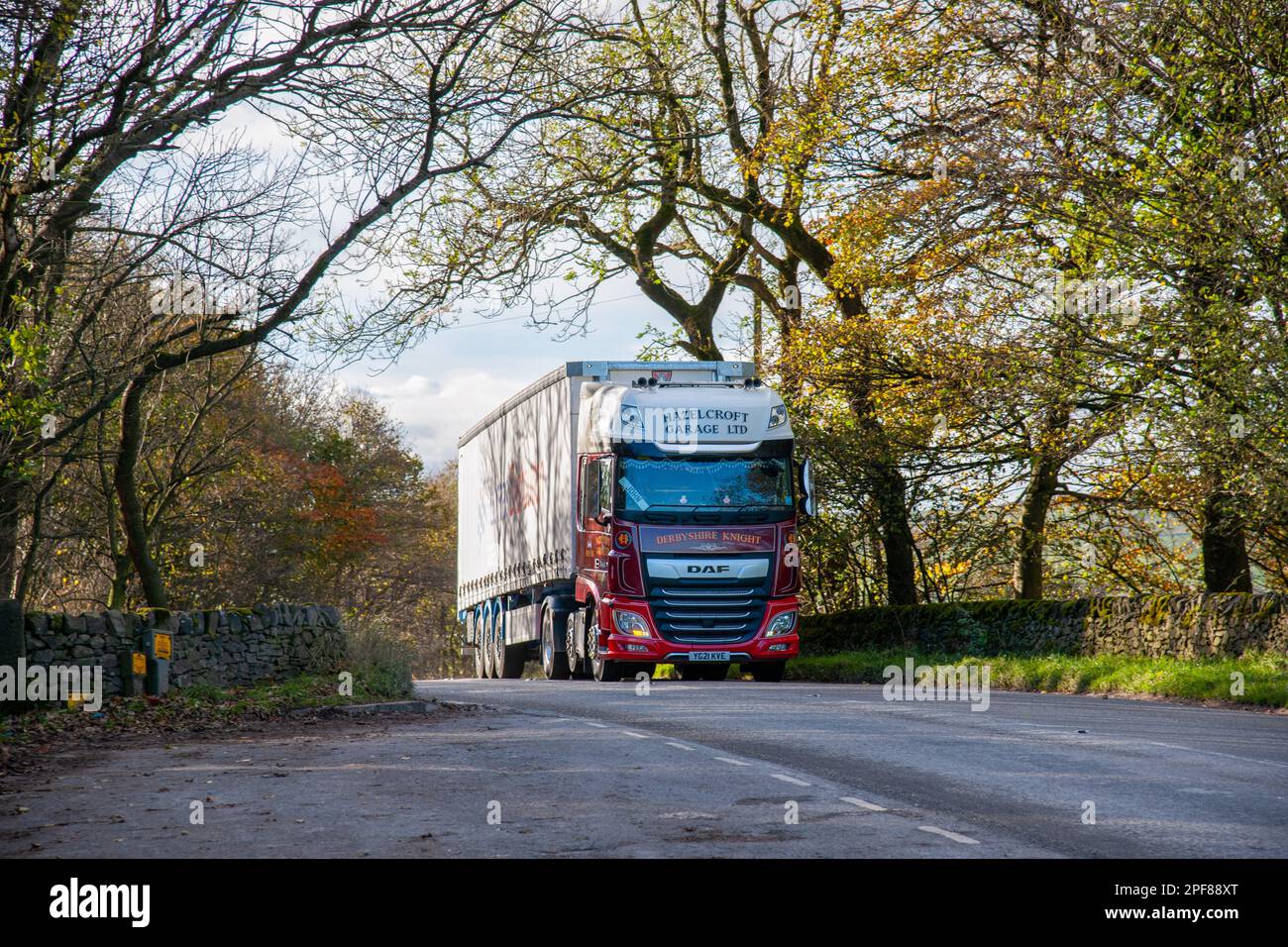 A DAF articulated truck pulling a curtainsider trailer on a rural road ...