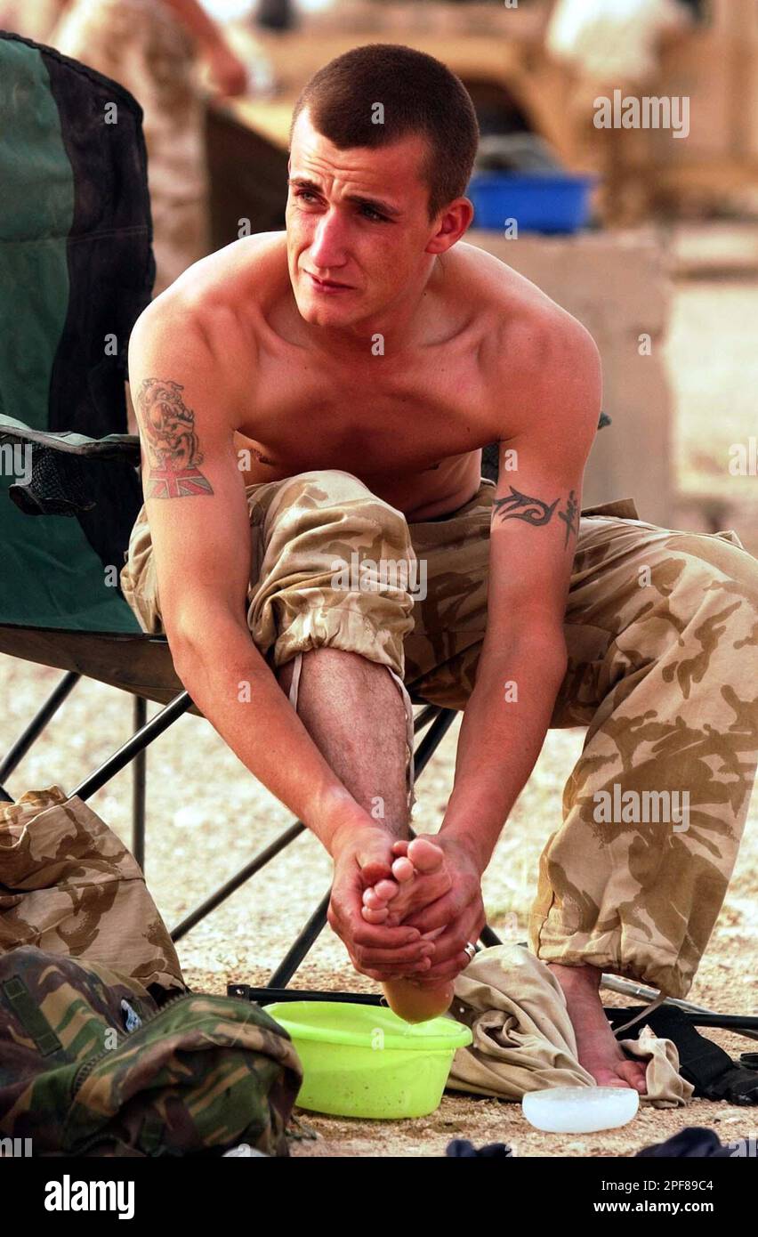 An unidentified Scots Dragoon Guard, of the British Army, takes a break ...