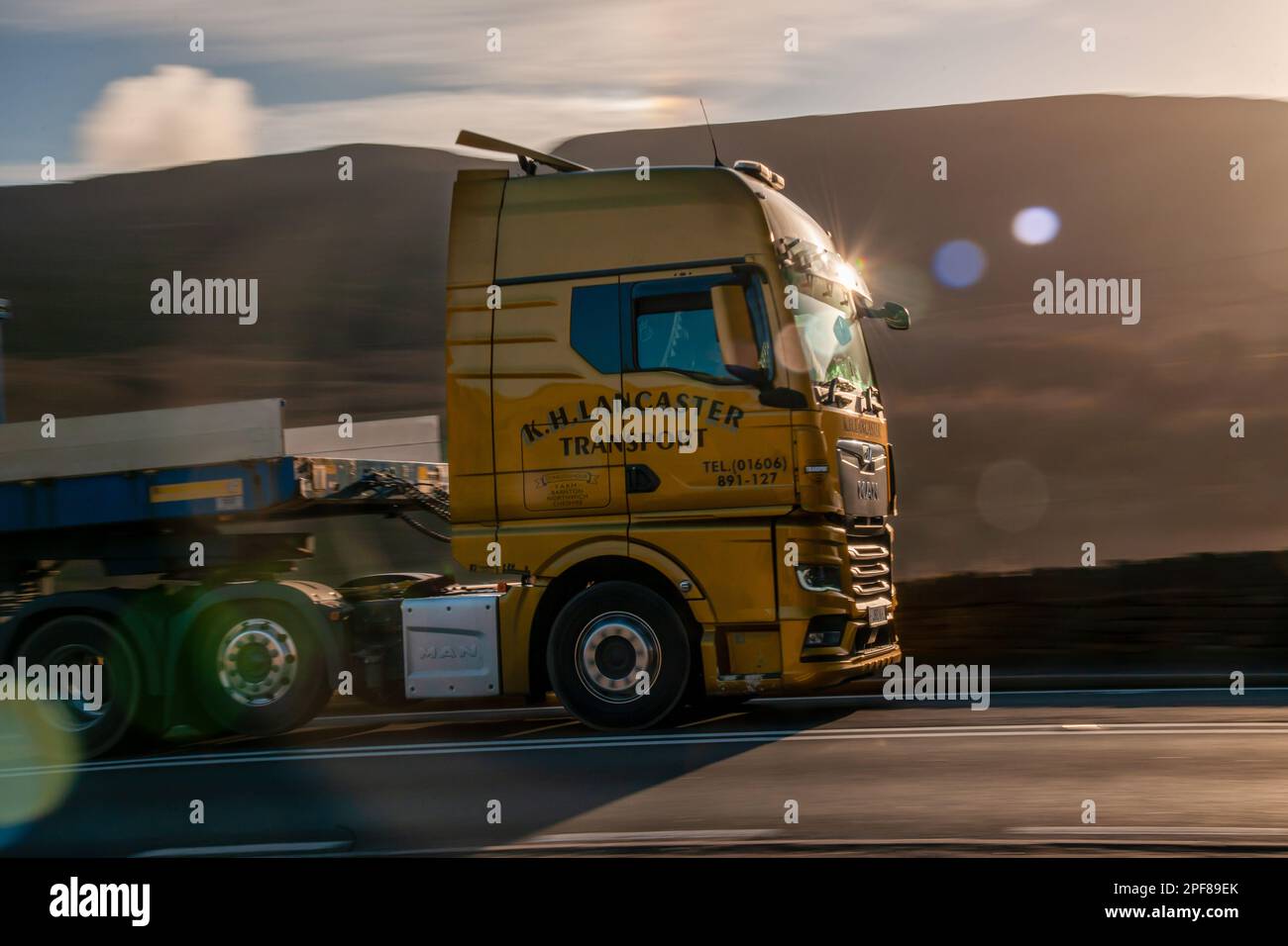 MAN truck pulling a flatbed trailer up the A628 Woodhead Pass Stock ...