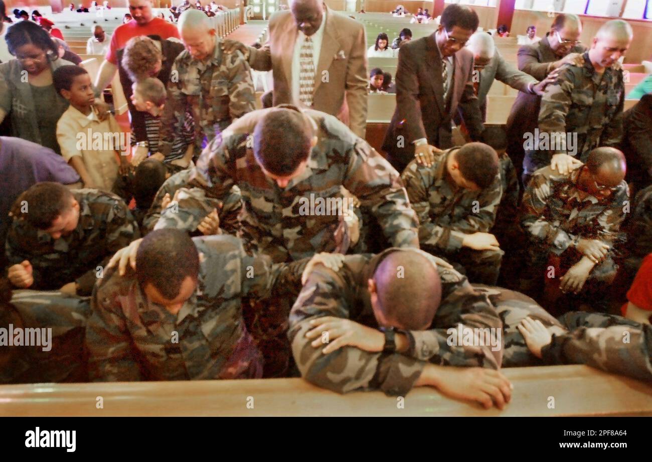Members of the Army National Guard pray with congregants during the ...