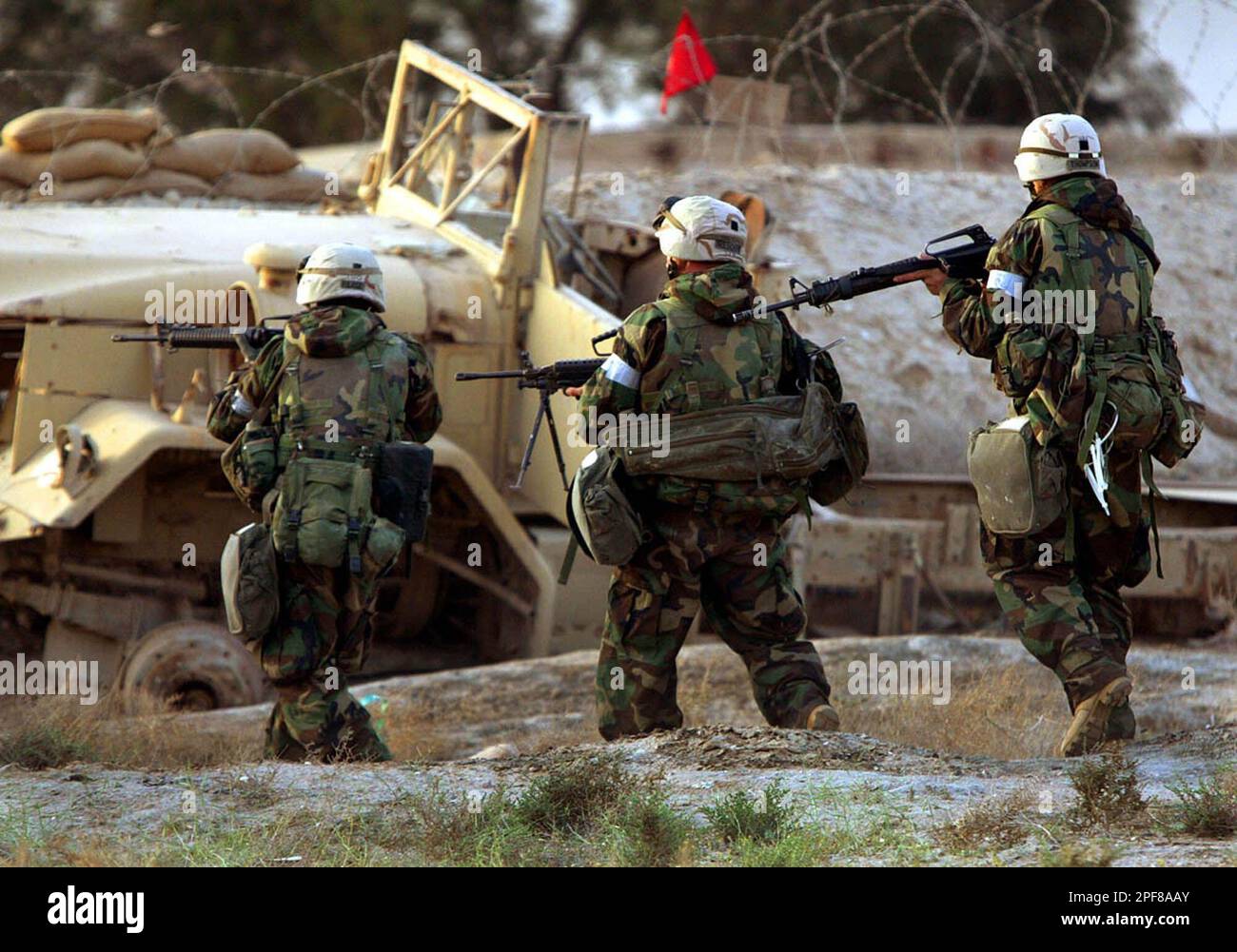 U.S. Marines from the15th Marine Expeditionary Unit aim their rifles as ...