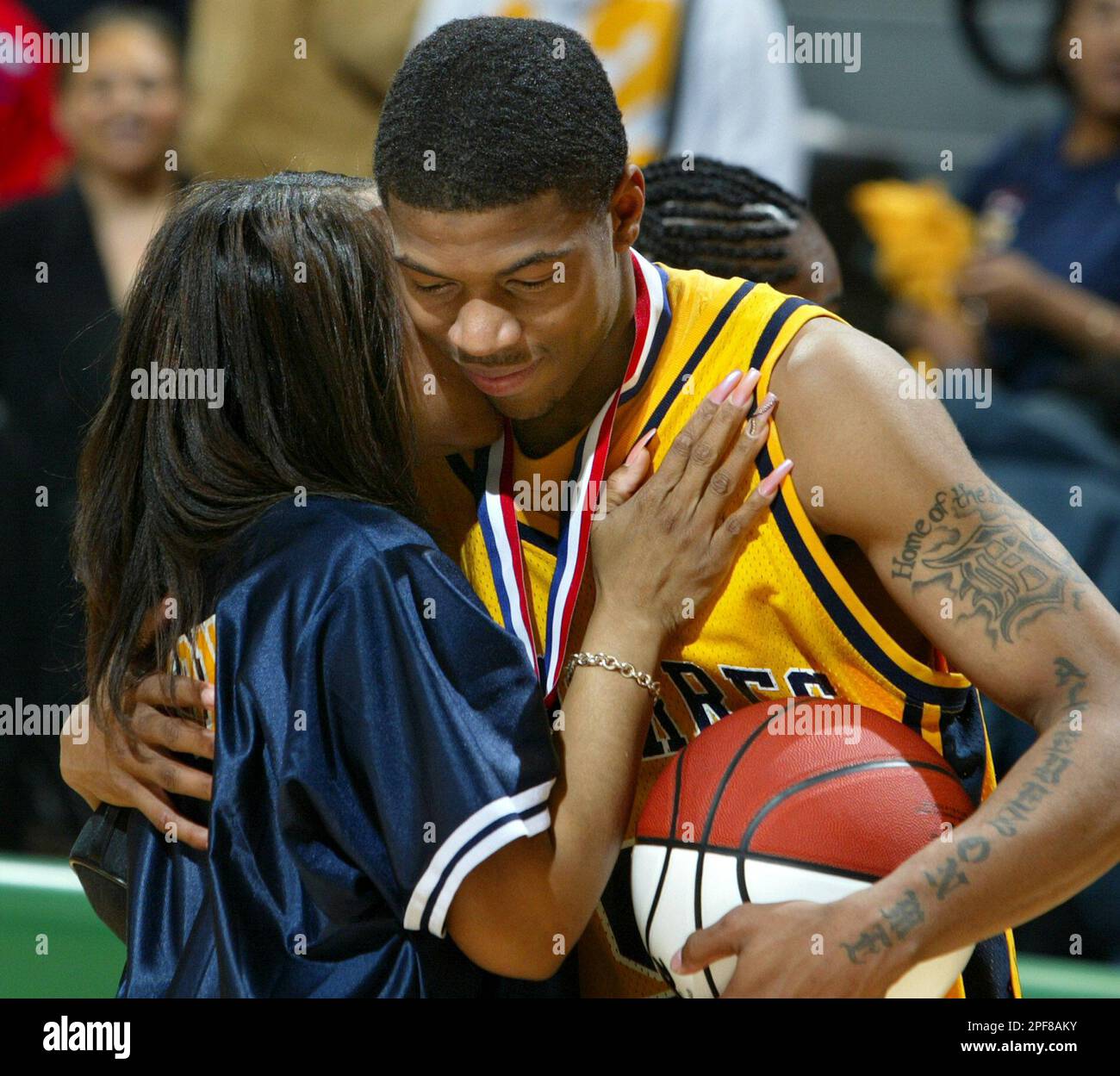 Detroit St. Martin dePorres' Brandon Cotton, right, gets a hug from his ...