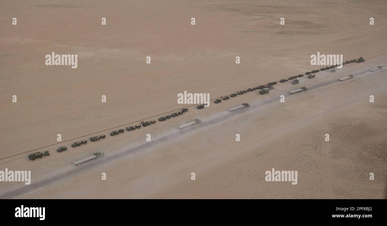* A convoy of trucks heads south past a convoy of military vehicles ...