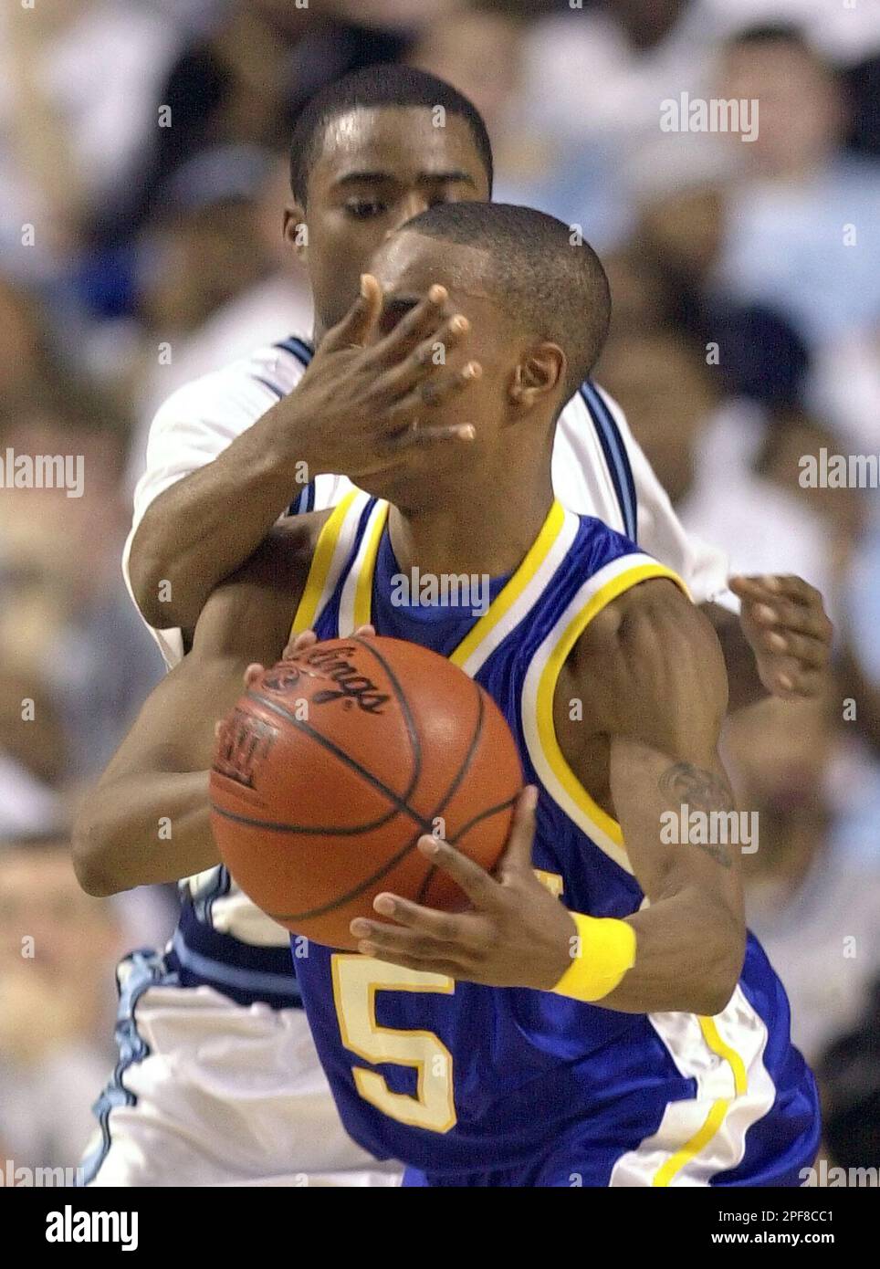 Henry Clay's Lamont Campbell (5) is slapped across the face by Iroquois ...