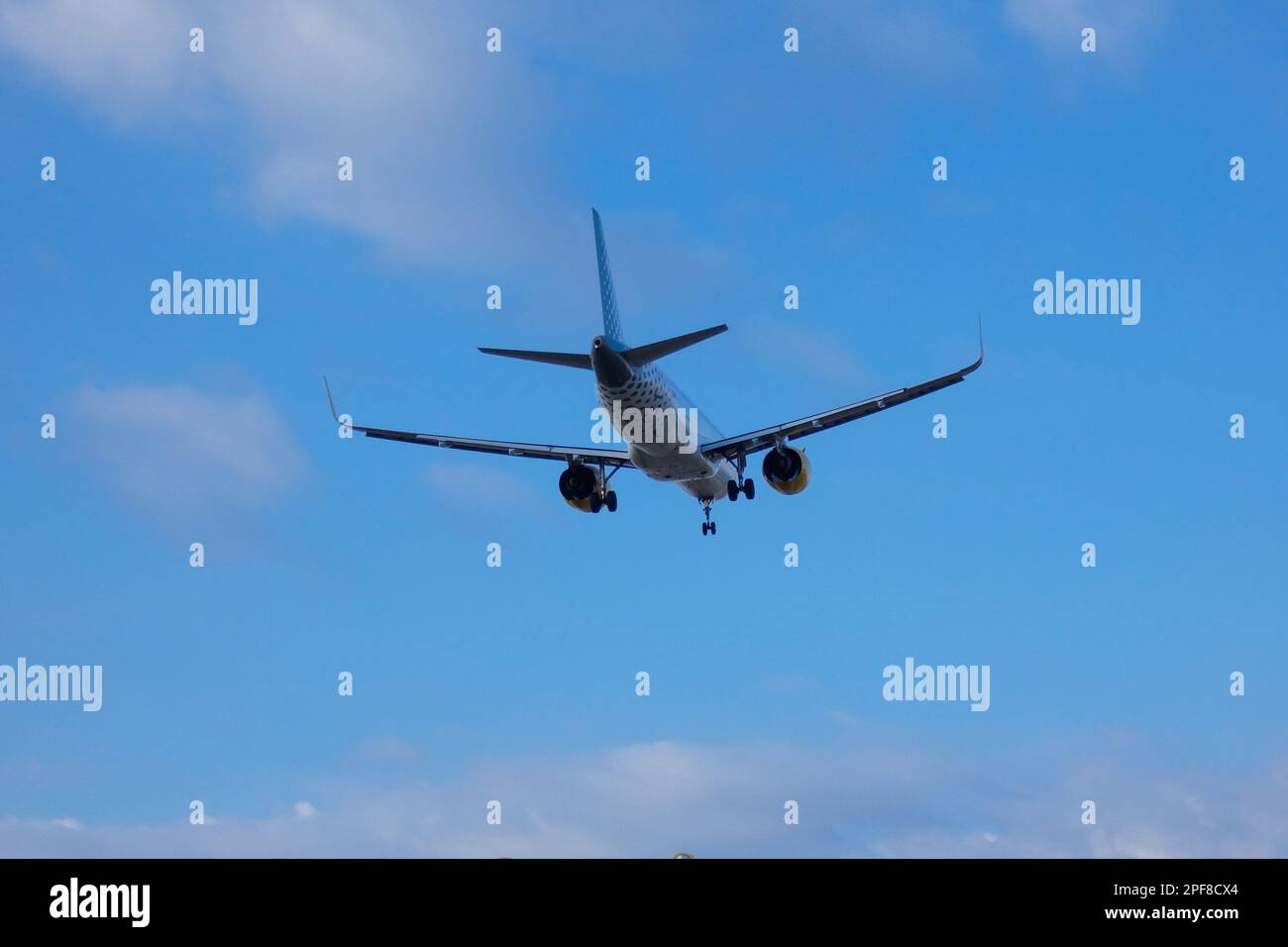 Commercial aircraft overflying the sky and arriving at airport Stock ...