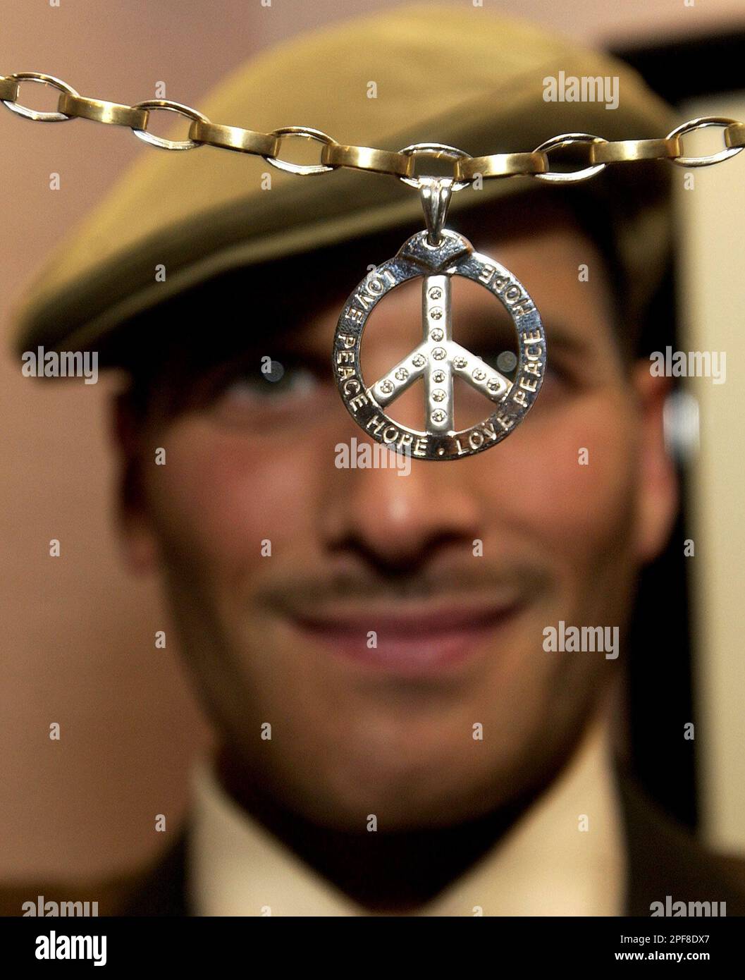 Celebrity stylist Philip Bloch examines a "Love Peace Hope" necklace at ...