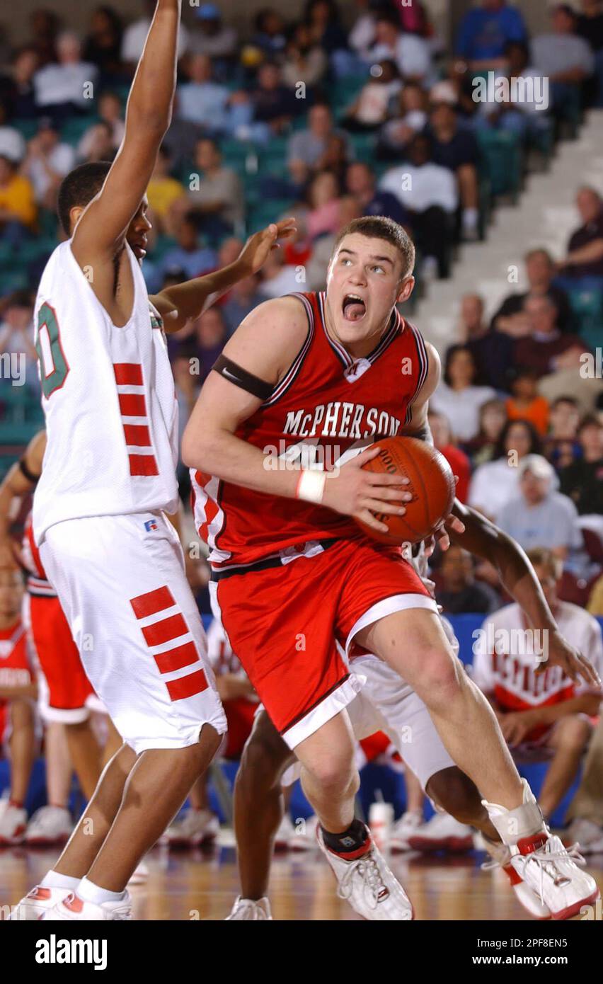 McPherson's Jordan Fithian, right, drives to the basket around Highland ...