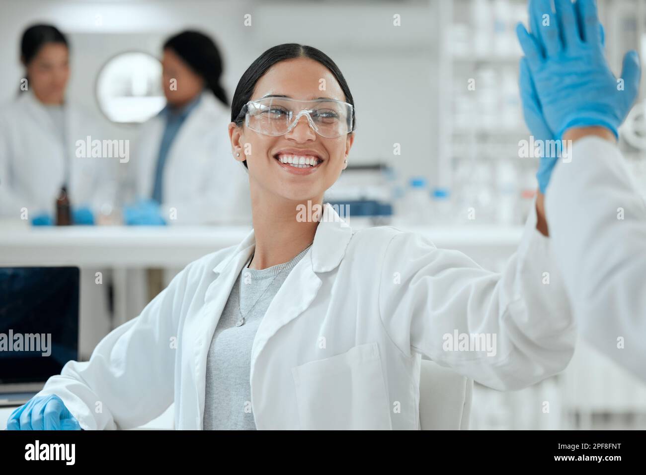 Congratulations on your achievements. two scientists high fiving one ...