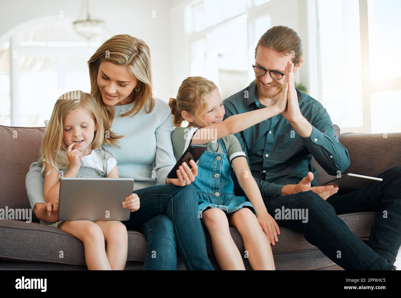 Weve all bonded in our own ways. a young family sitting on the sofa ...
