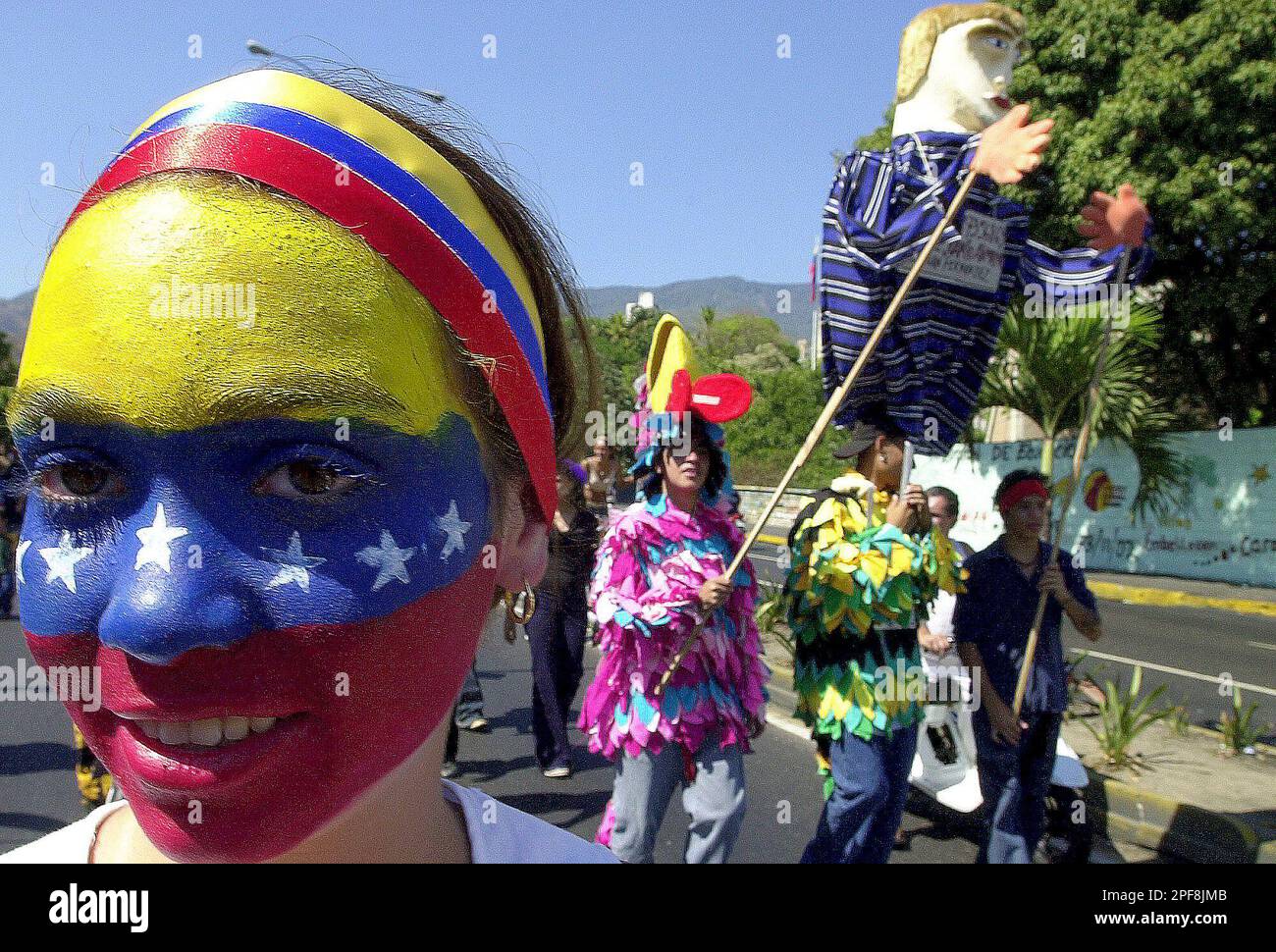 A Venezuelan girl with her face painted in the national colors ...