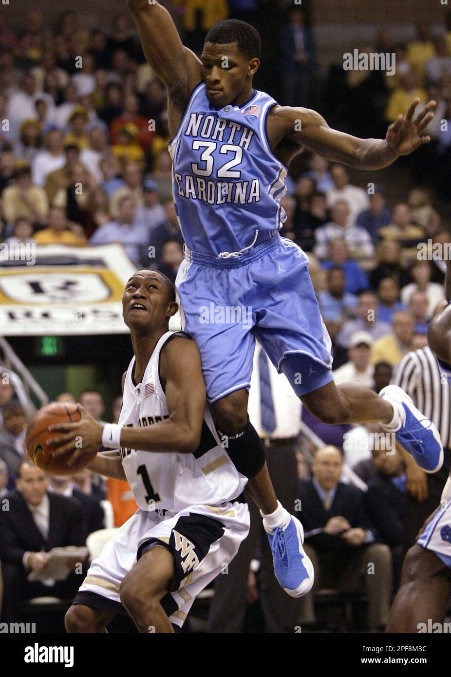North Carolina's Rashad McCants (32) falls into Wake Forest's Justin ...