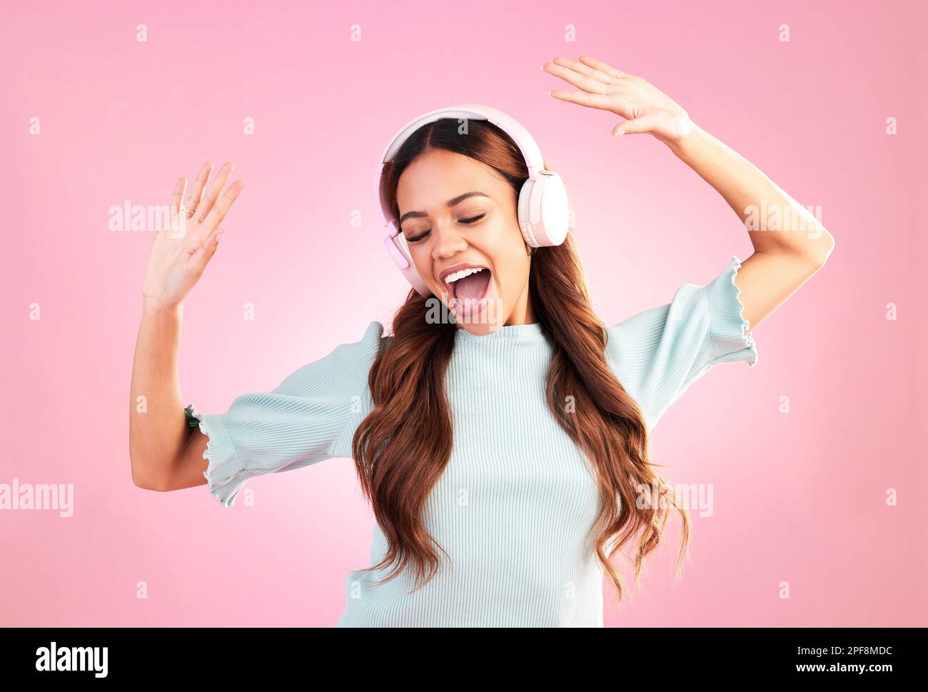 Music headphones, dancing and woman singing in studio isolated on a ...