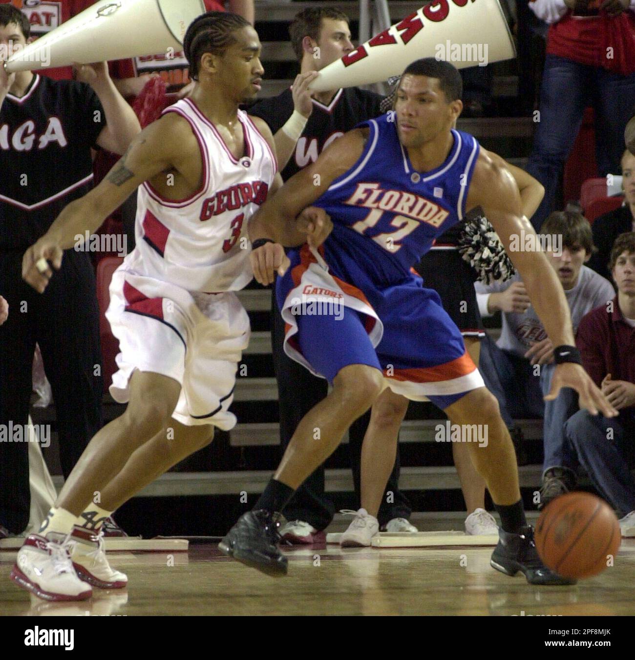 Florida's Justin Hamilton (12) gets tangled up with Georgia's Rashad ...