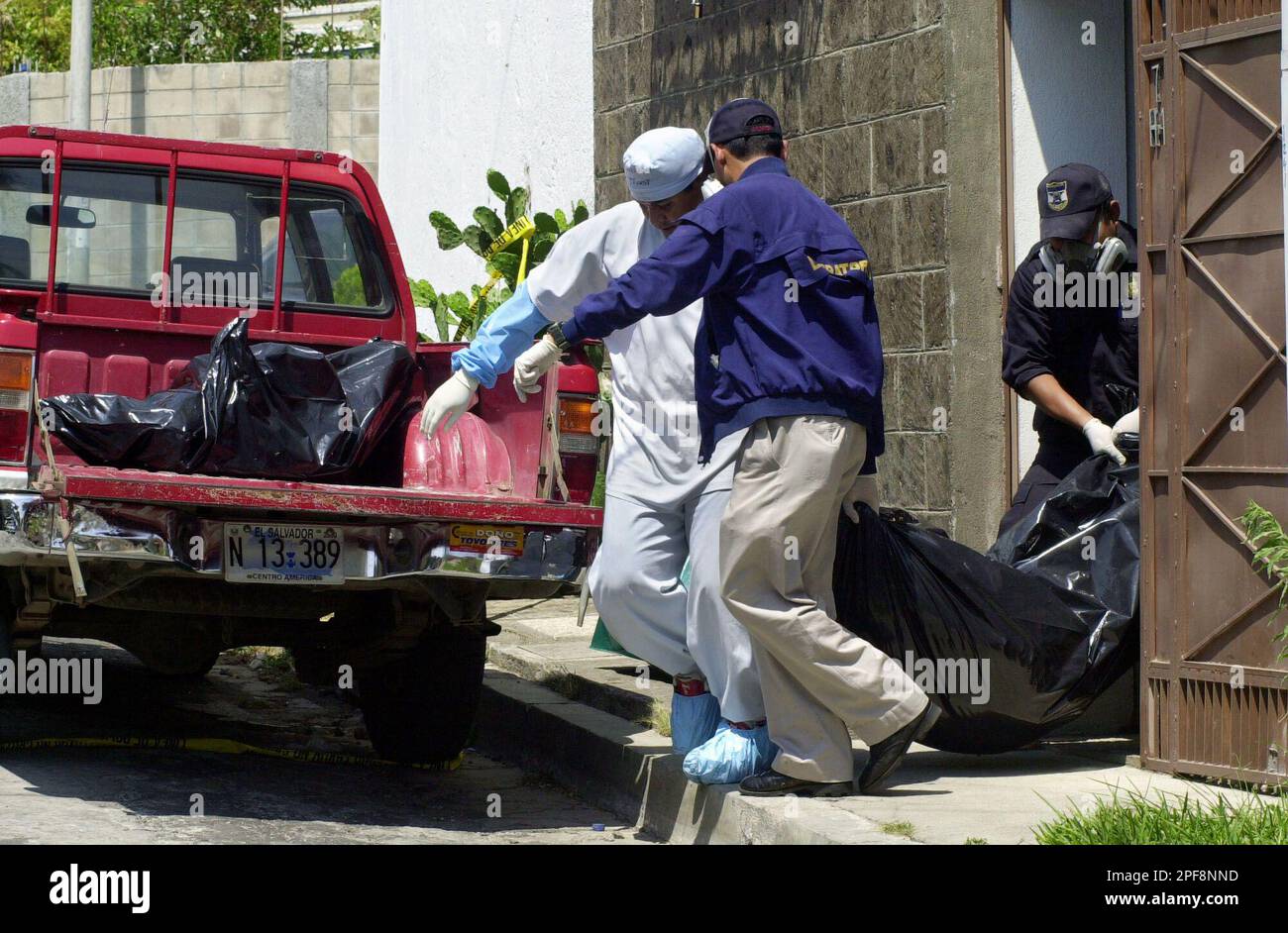 Police and city medical workers drag the bodies of what police said ...