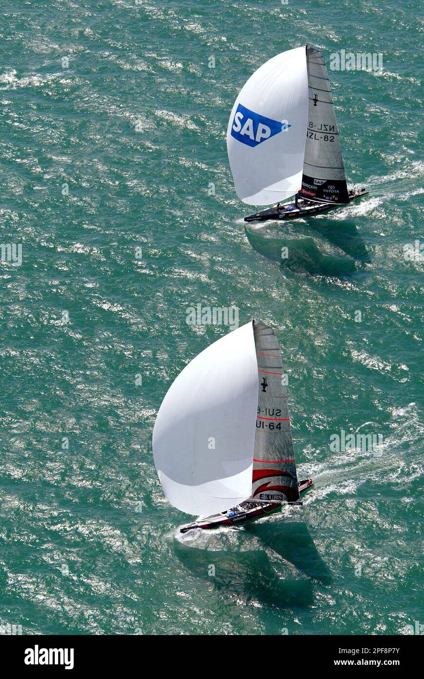 Team New Zealand, top, and Switzerland's Alinghi race downwind during ...