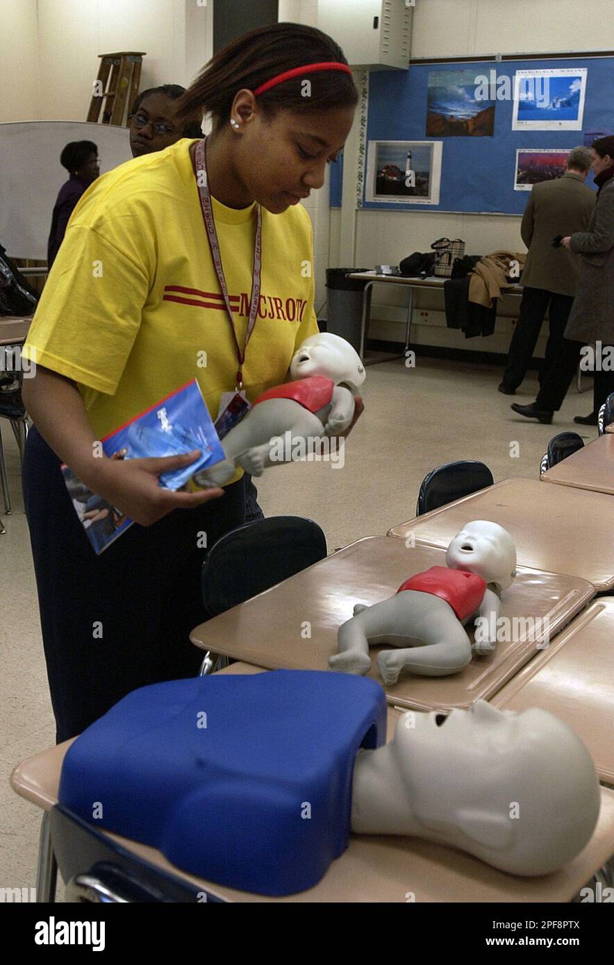 Curie high school student Michelle Collins replaces an infant dummy ...