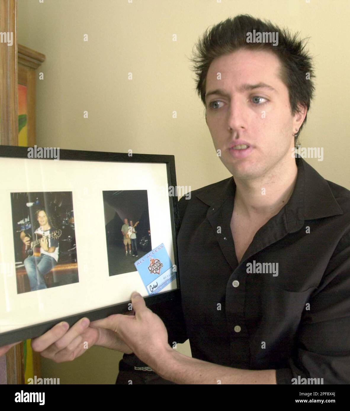 Mark Zicari, 26, holds framed photos of his roommate, Great White ...