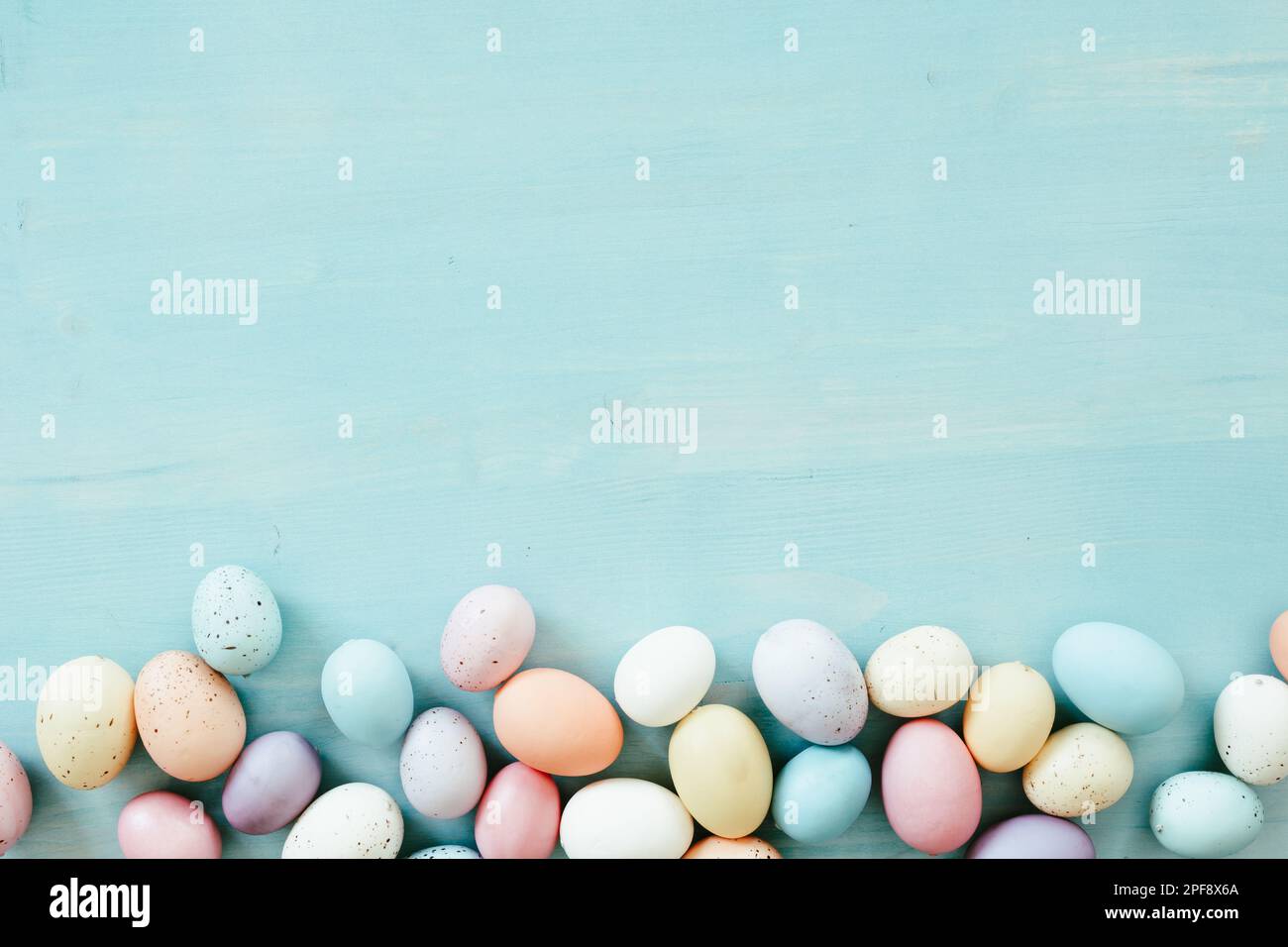 Border of easter eggs on a blue wood background with copy space Stock ...