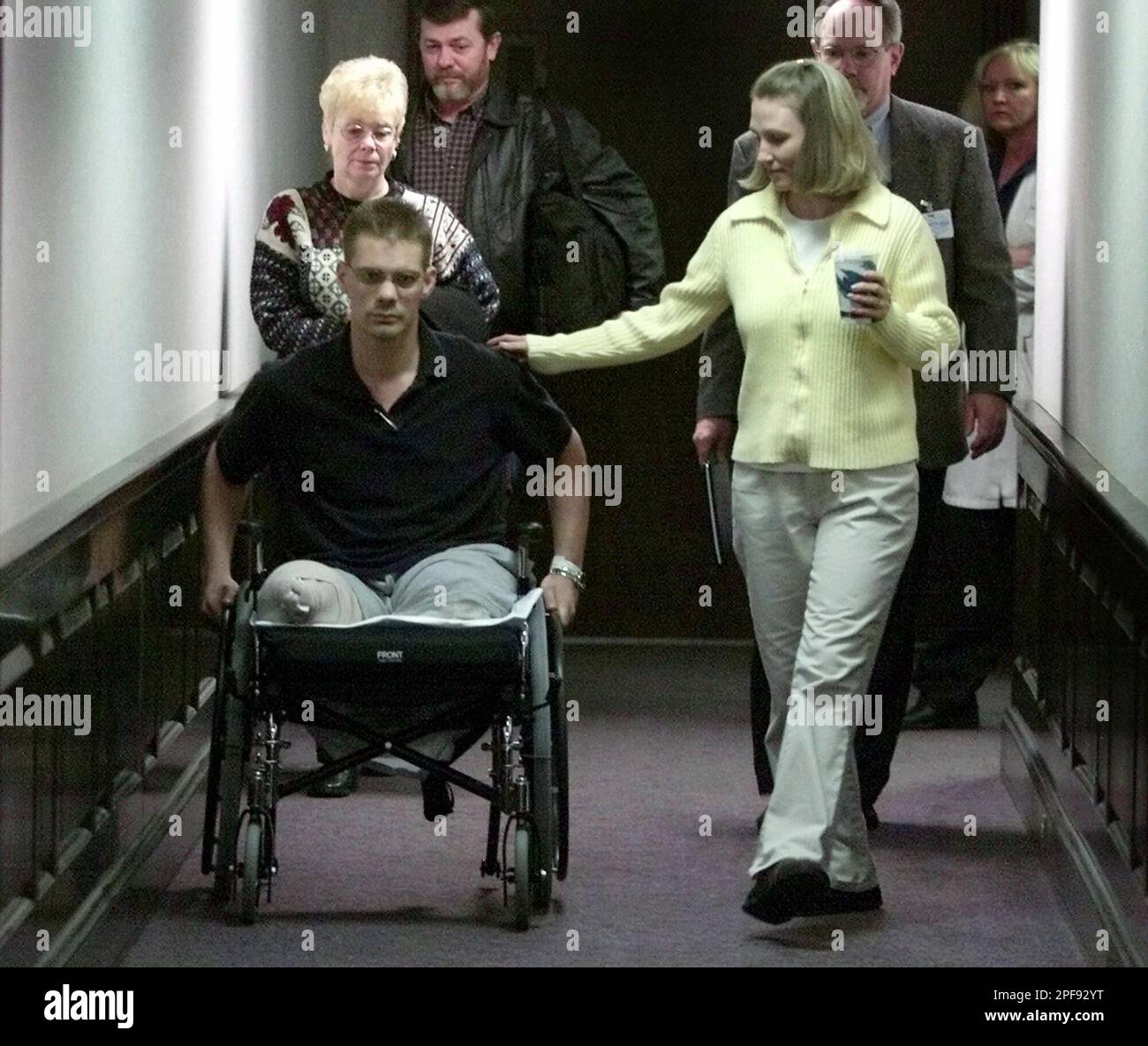 Paramedic Tim Hayes, left, arrives with his wife, Susan, right, for a ...