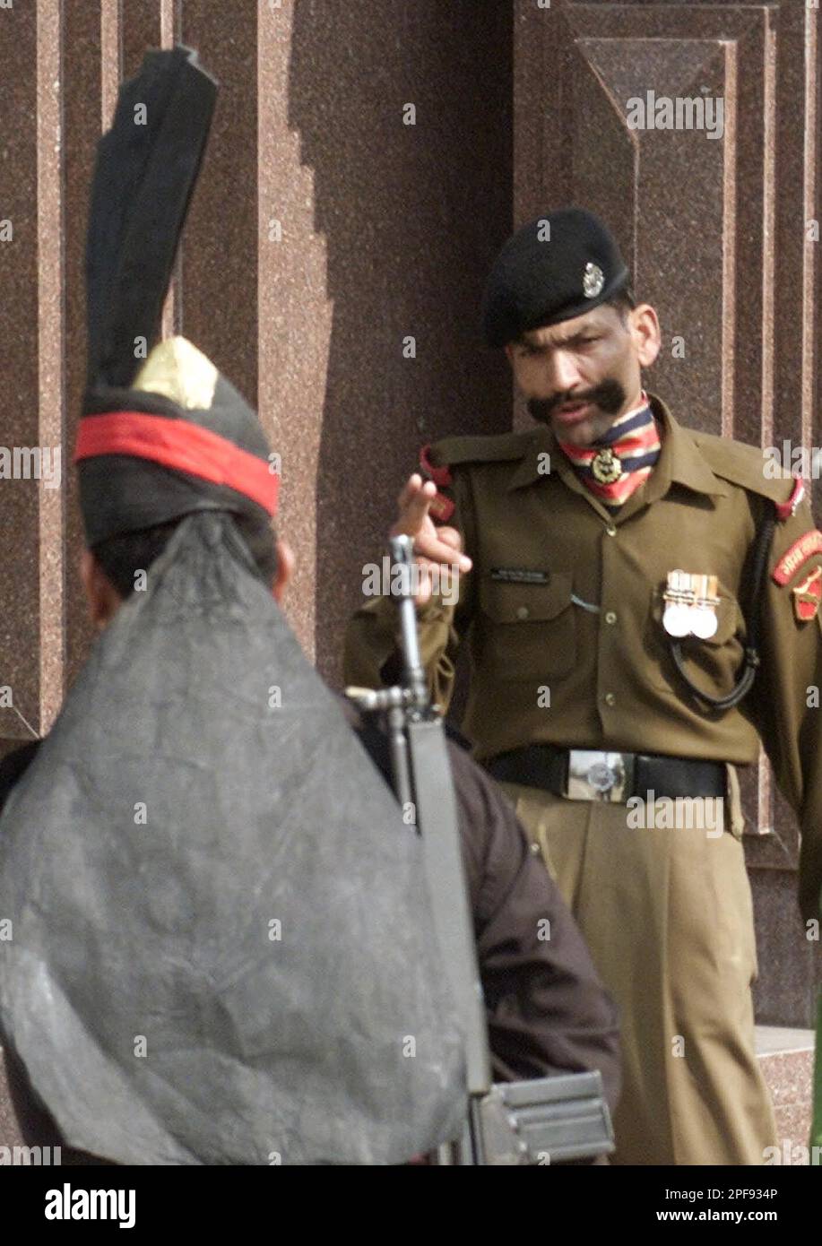 Indian, right, and his counterpart Pakistani border guard talk each ...