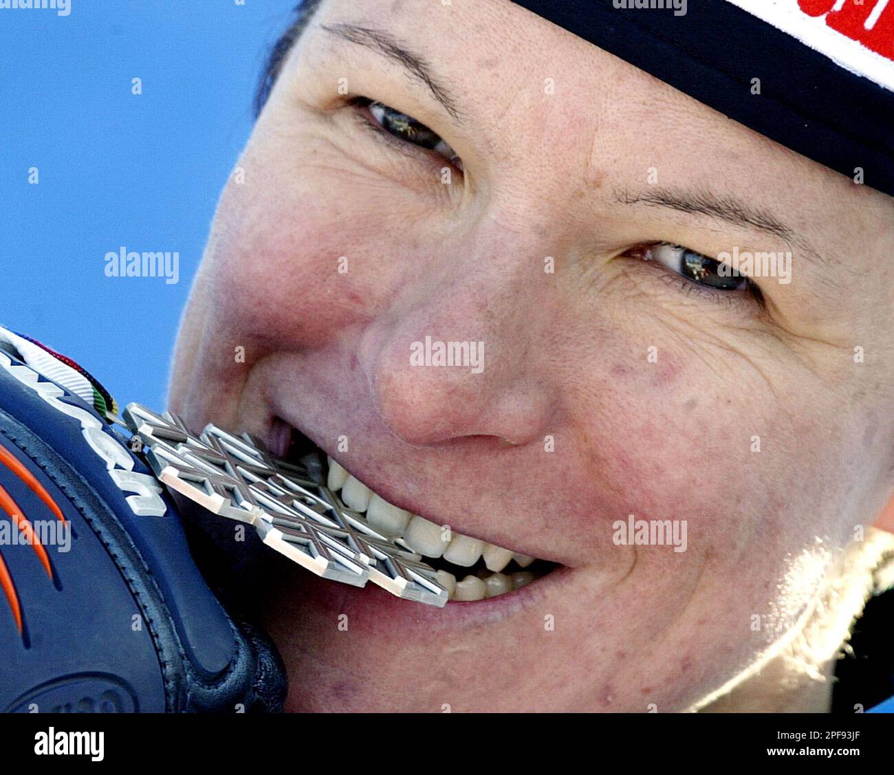Swiss Corinne Rey Bellet bites the silver medal she won in the women's ...