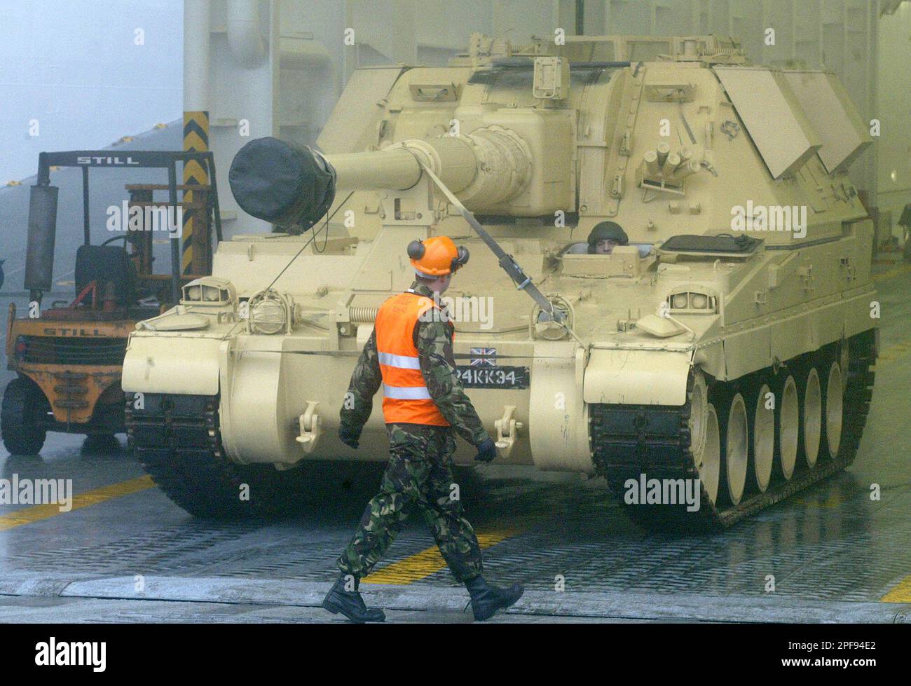 British soldiers load a self-propelled AS90 howitzer on the vessel ...