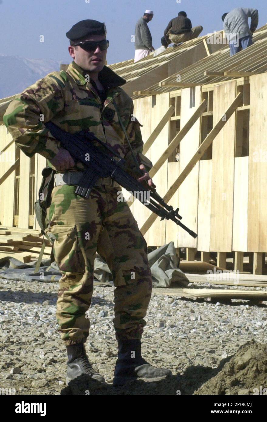 Italian soldier Enrico Tuzzino keeps watch at a construction site ...