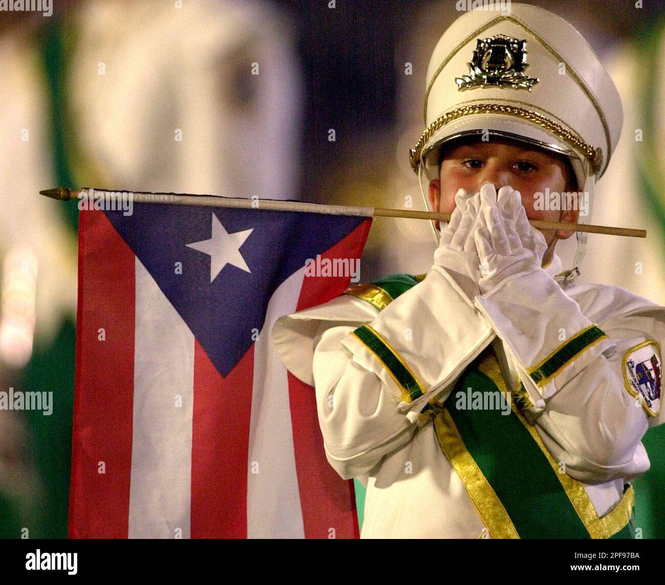 Oscar Oman Rivera Negron, 7, holds the Puerto Rican flag as a band ...