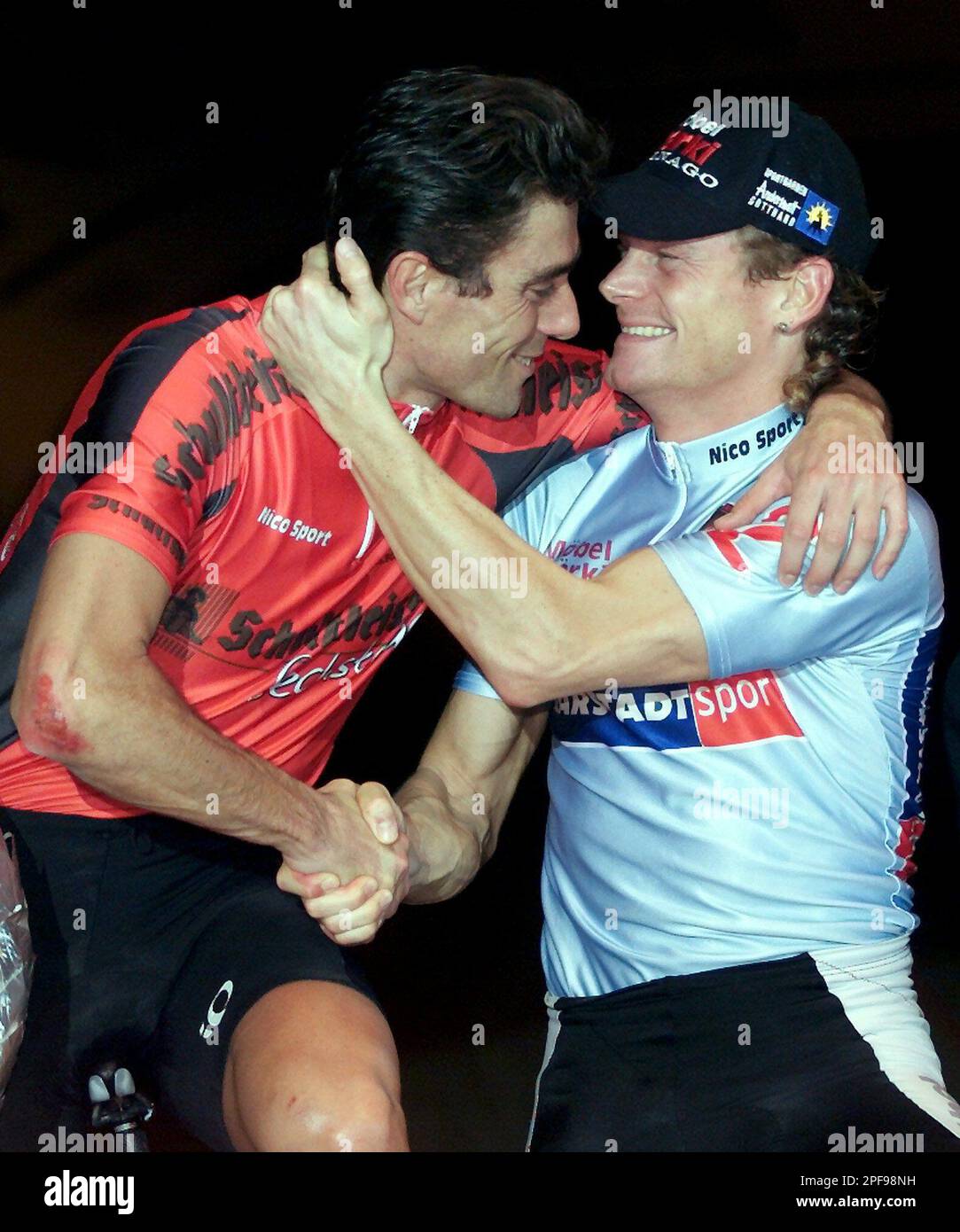 Bruno Risi, right, from Switzerland, embraces Italian Silvio Martinello ...