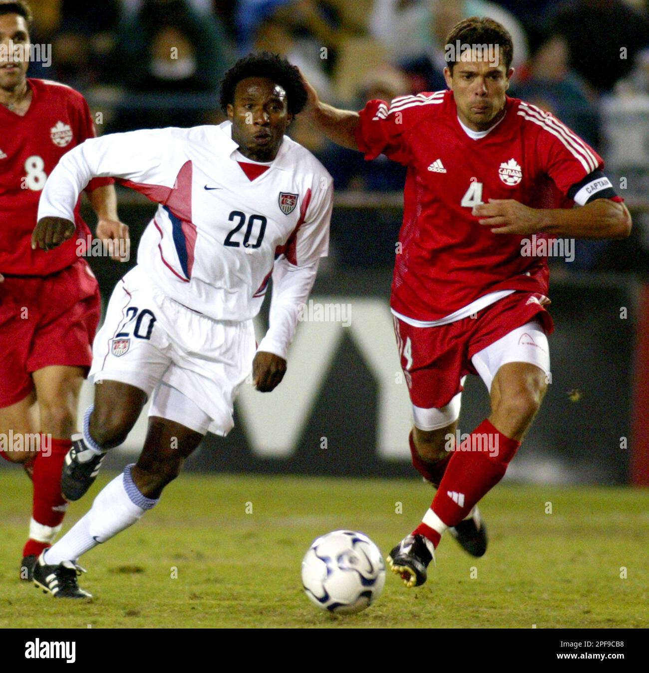 USA team Jeff Cunningham (20) moves the ball downfield with Canada ...