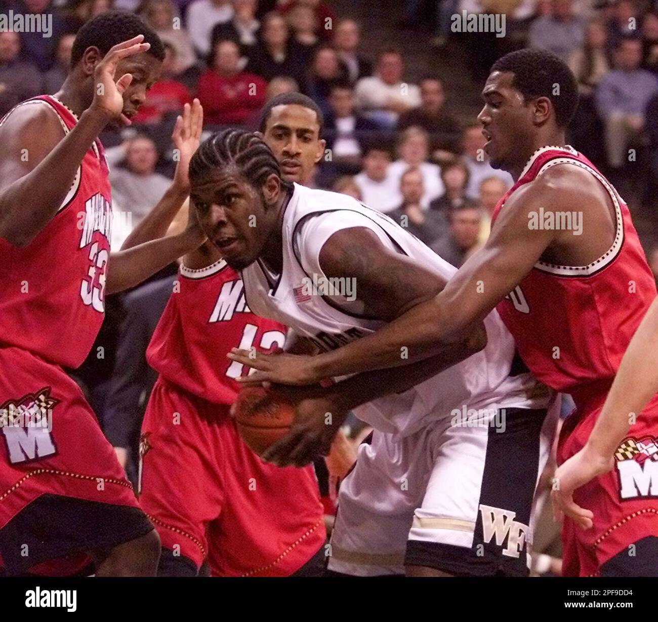 Wake Forest's Eric Williams, center, is surrounded by Maryland players ...