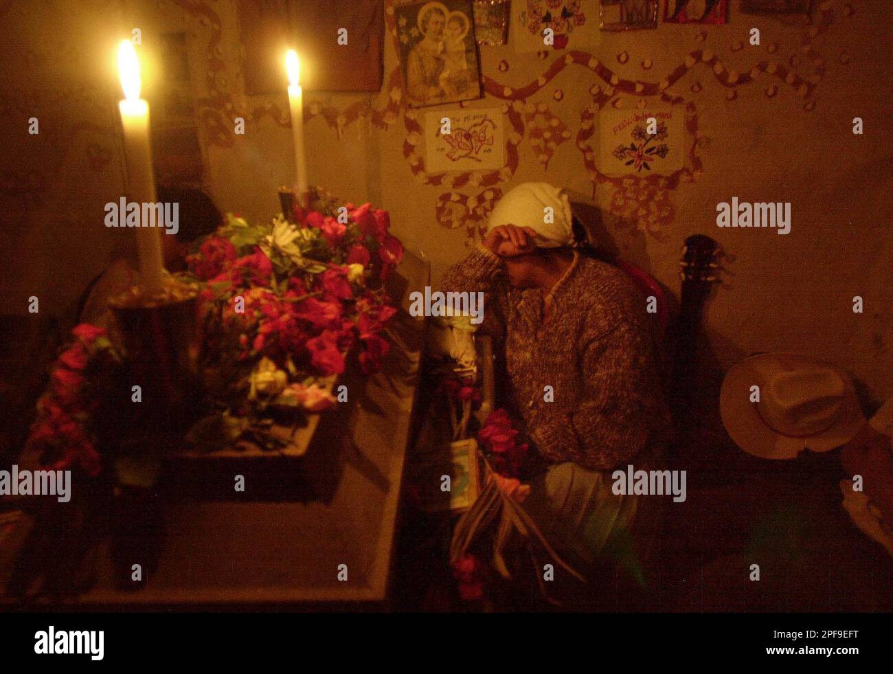* Maria Osorio sits next to the coffin of her son in Agua Salada, 104 ...