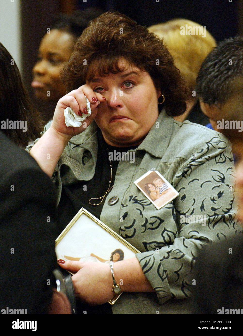Angela Balderson, the aunt of murder victim Leslie Keckler, wipes a ...