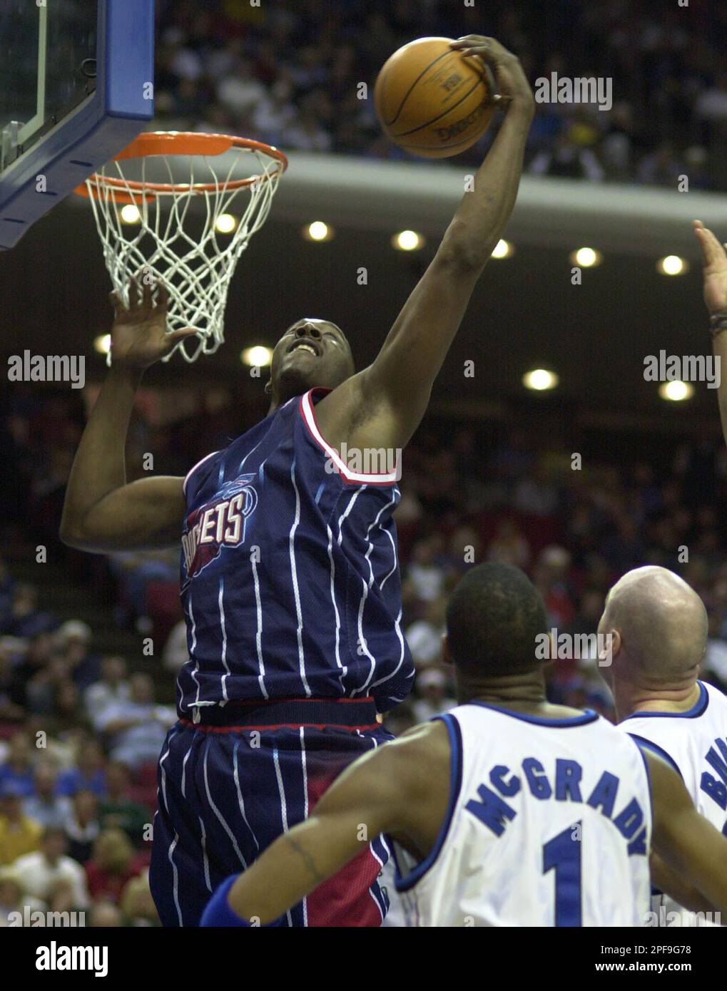 Houston Rockets' Kelvin Cato, left, gets by Orlando Magic defenders ...