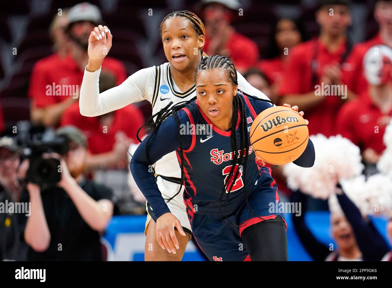 St. John's guard Mimi Reid (2) pushes the ball past Purdue guard Jayla ...