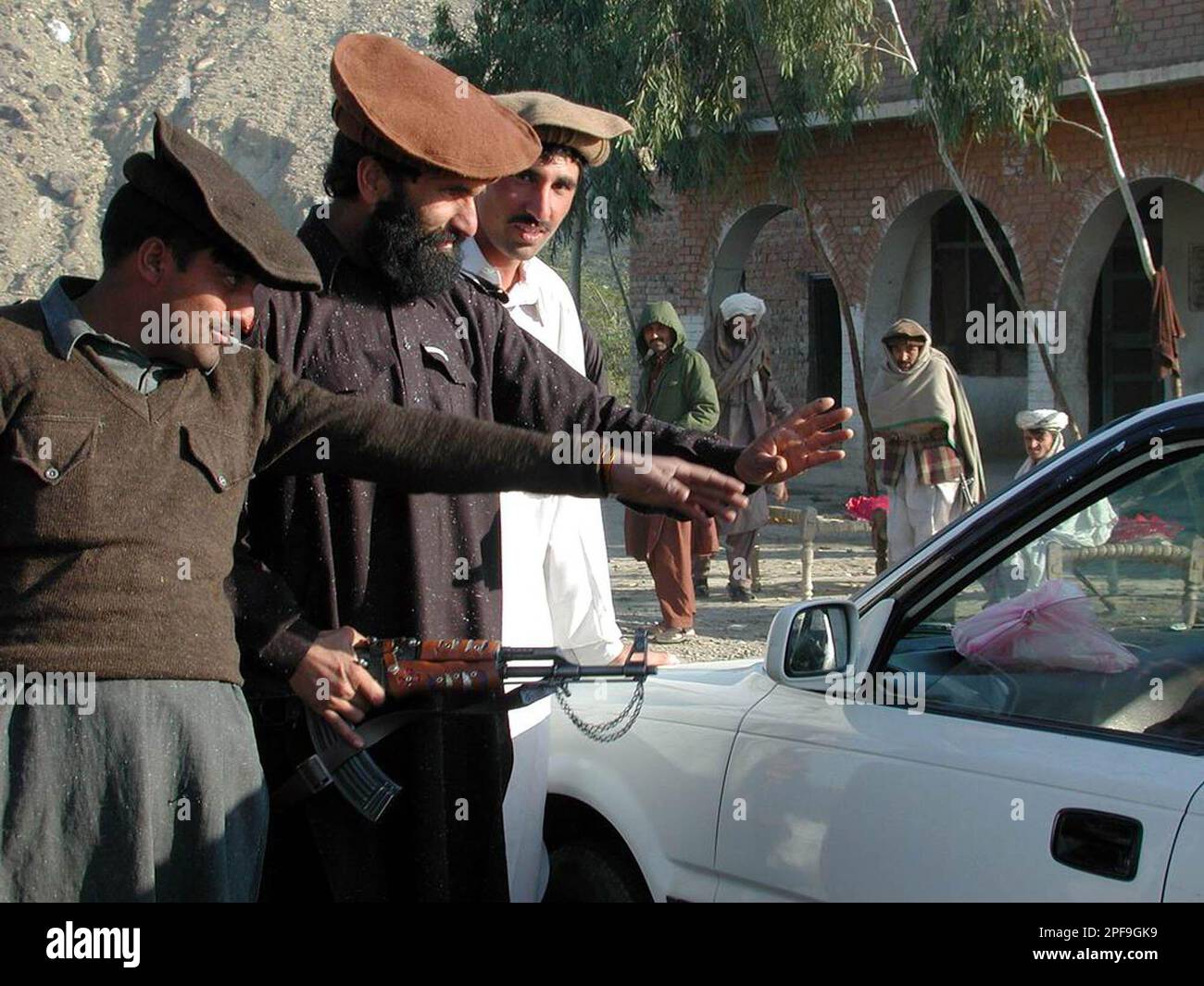 Pakistani border guards stop a car for security check as the car is ...