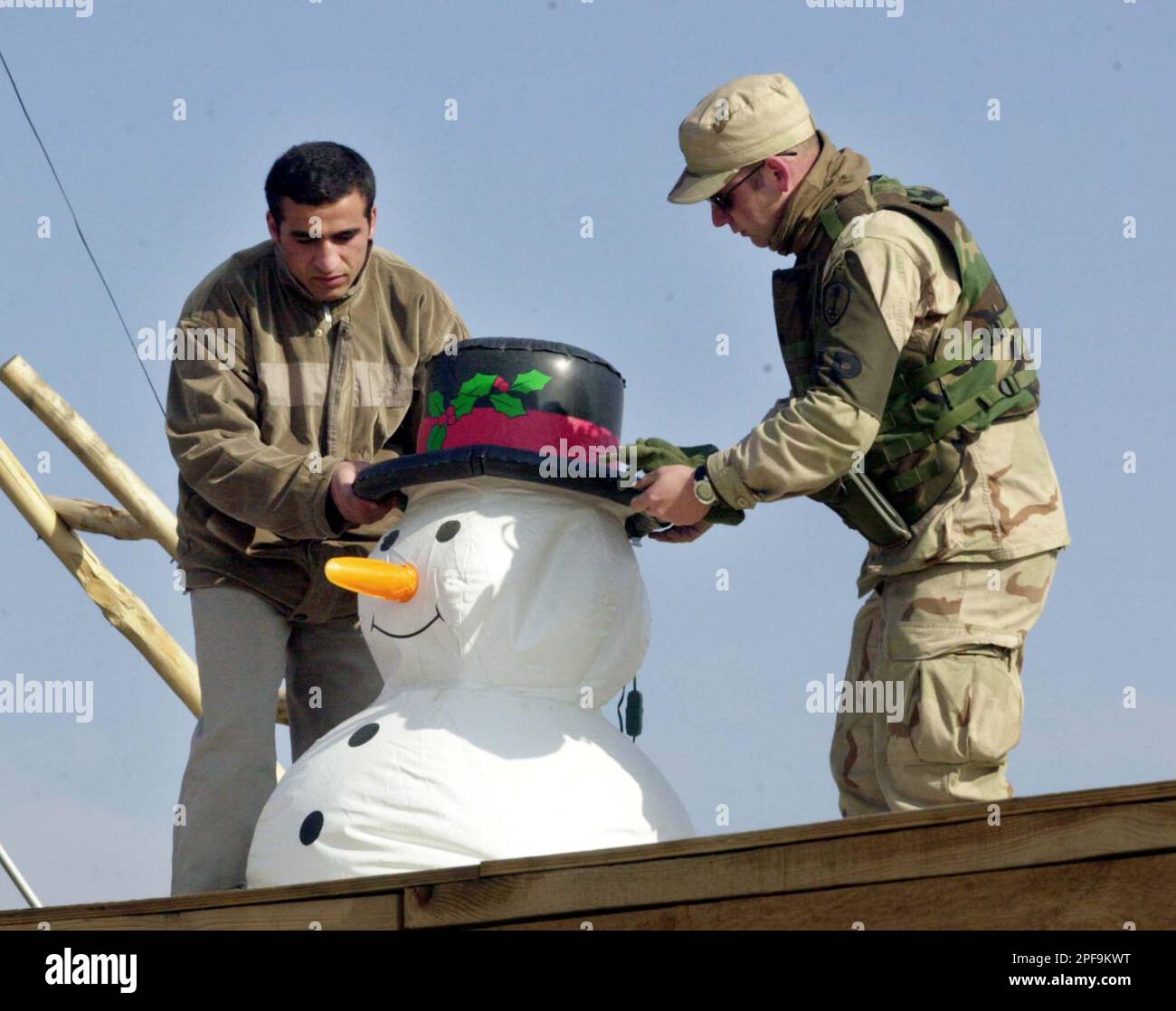 Corporal Jeremy Helderman, right, of Indianapolis, In., is assisted by ...