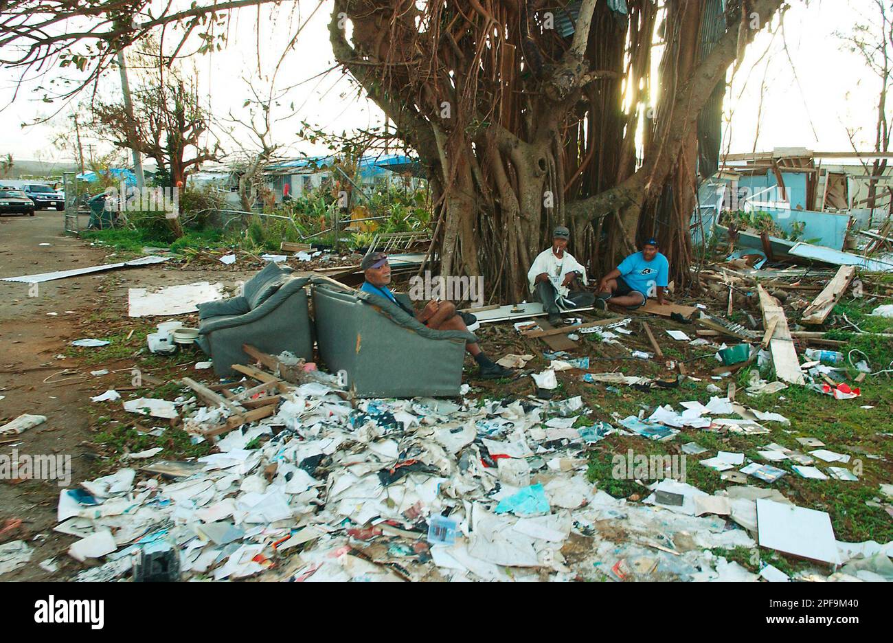 Residents take a break from cleaning up damages caused by typhoon ...