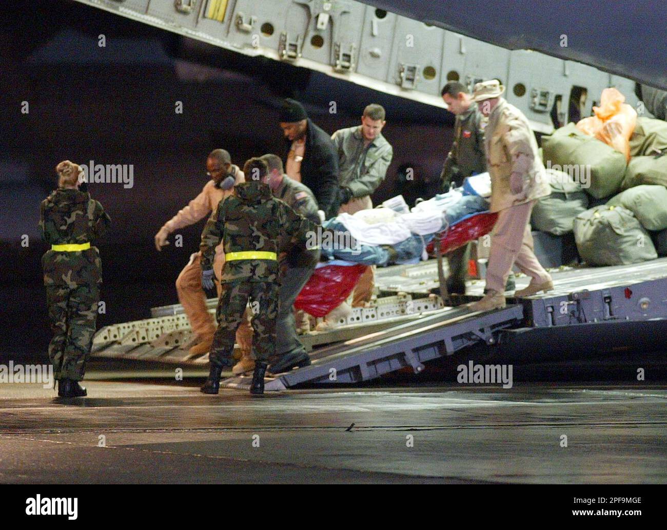 An injured U.S. soldier is carried off an airplane to an ambulance at ...