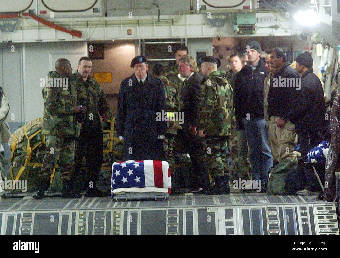 U.S. soldiers in the cargo bay of a C-17 military cargo plane stand ...